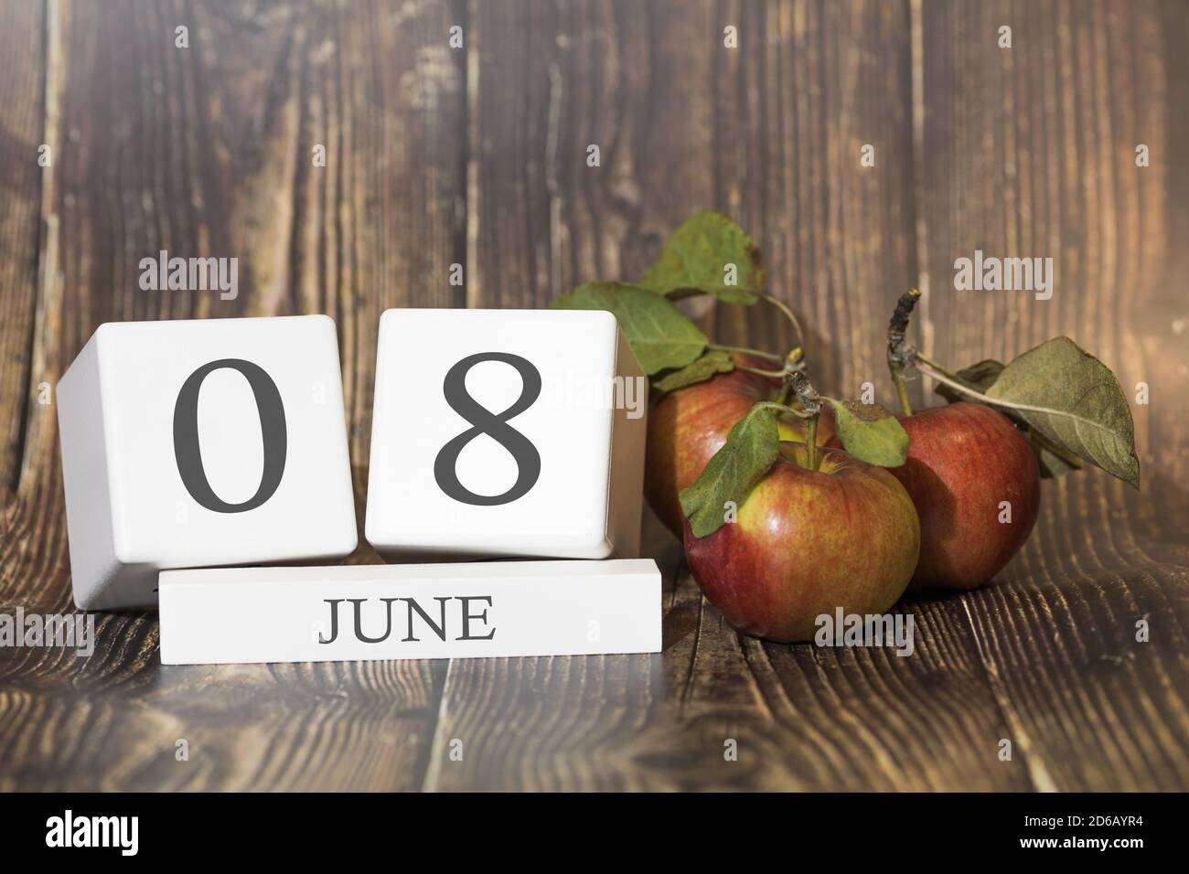 June 8. Day 08 of month. Calendar cube on wooden background with red ...