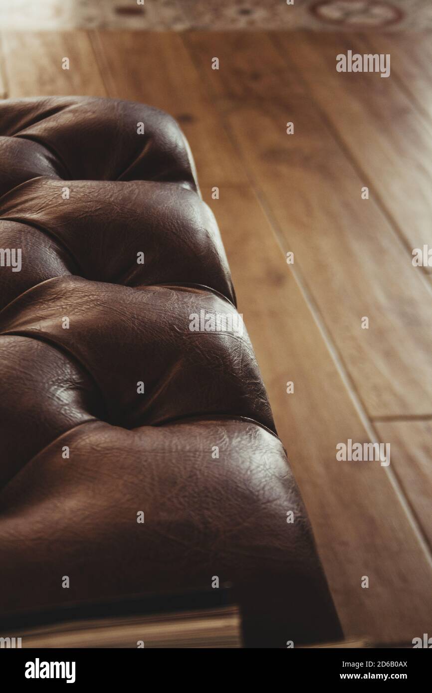 Embossed brown leather sofa on the wooden floor Stock Photo - Alamy