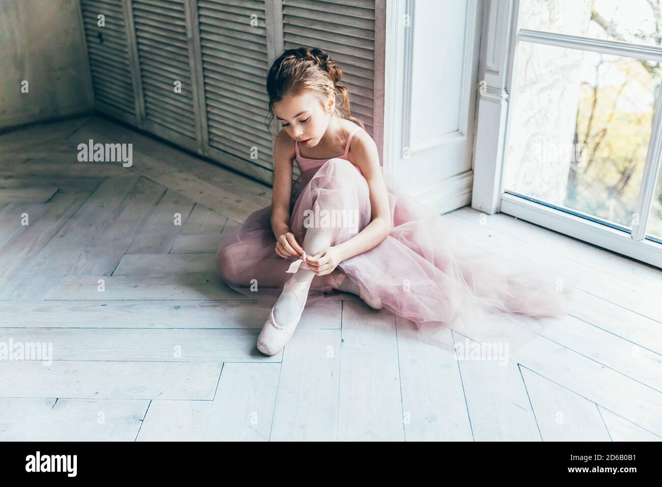Young classical ballet dancer girl in dance class. Beautiful graceful ...