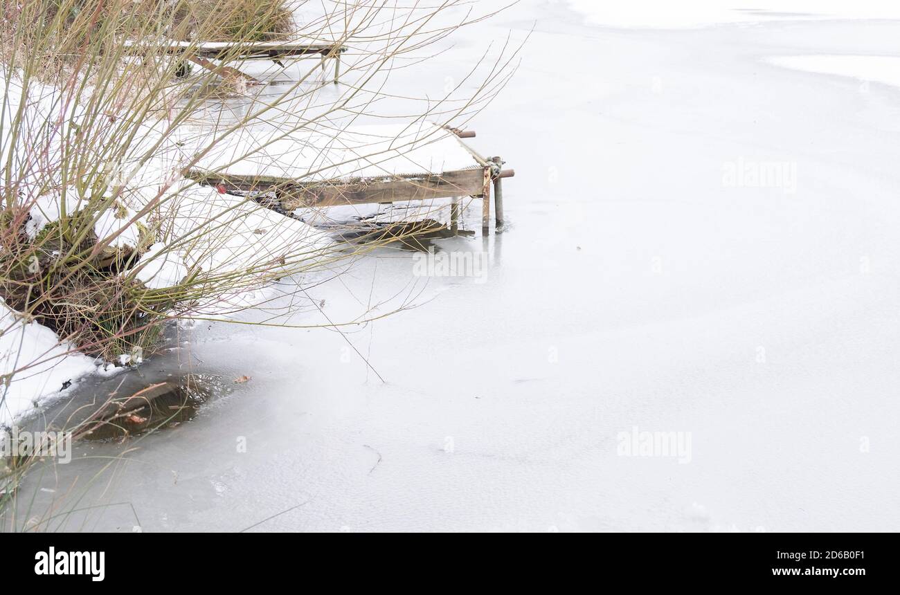 Frozen over fishing lake image Stock Photo - Alamy