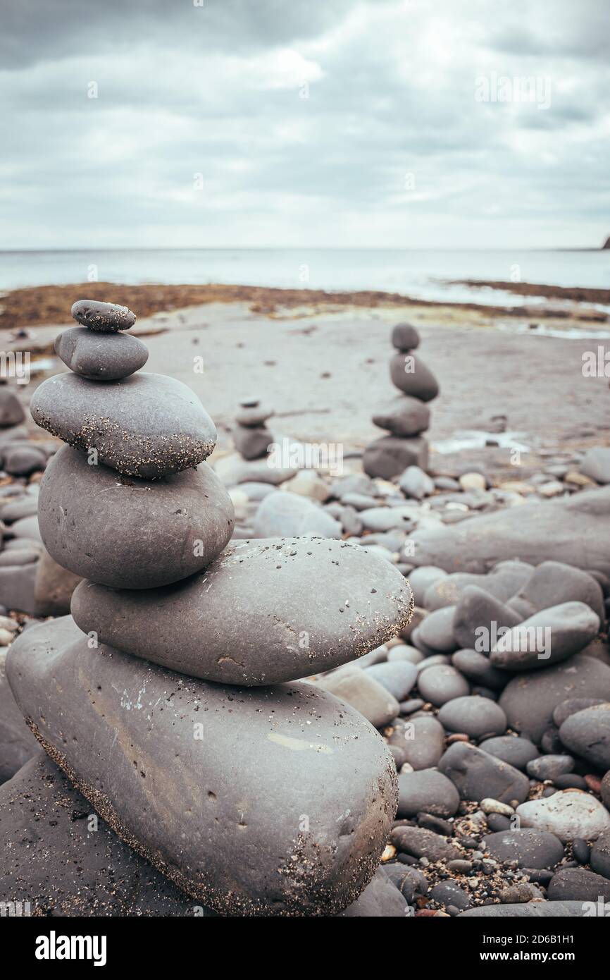 Stacked rocks into a standing still formation, pebbles by the beach put ...