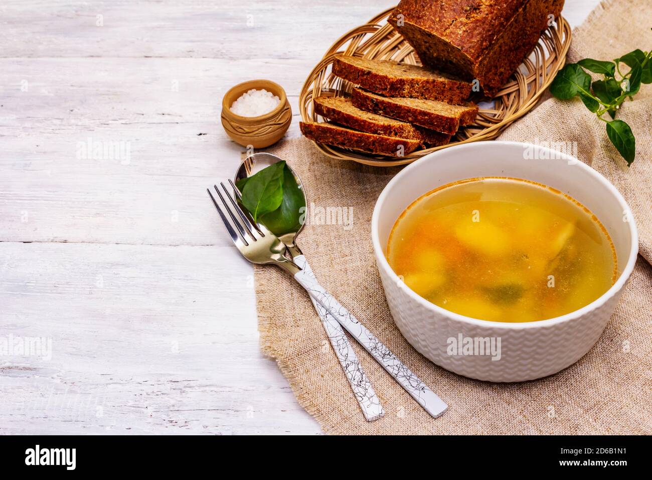 Trout soup with cutting vegetables and toasted bread. Traditional hot ...
