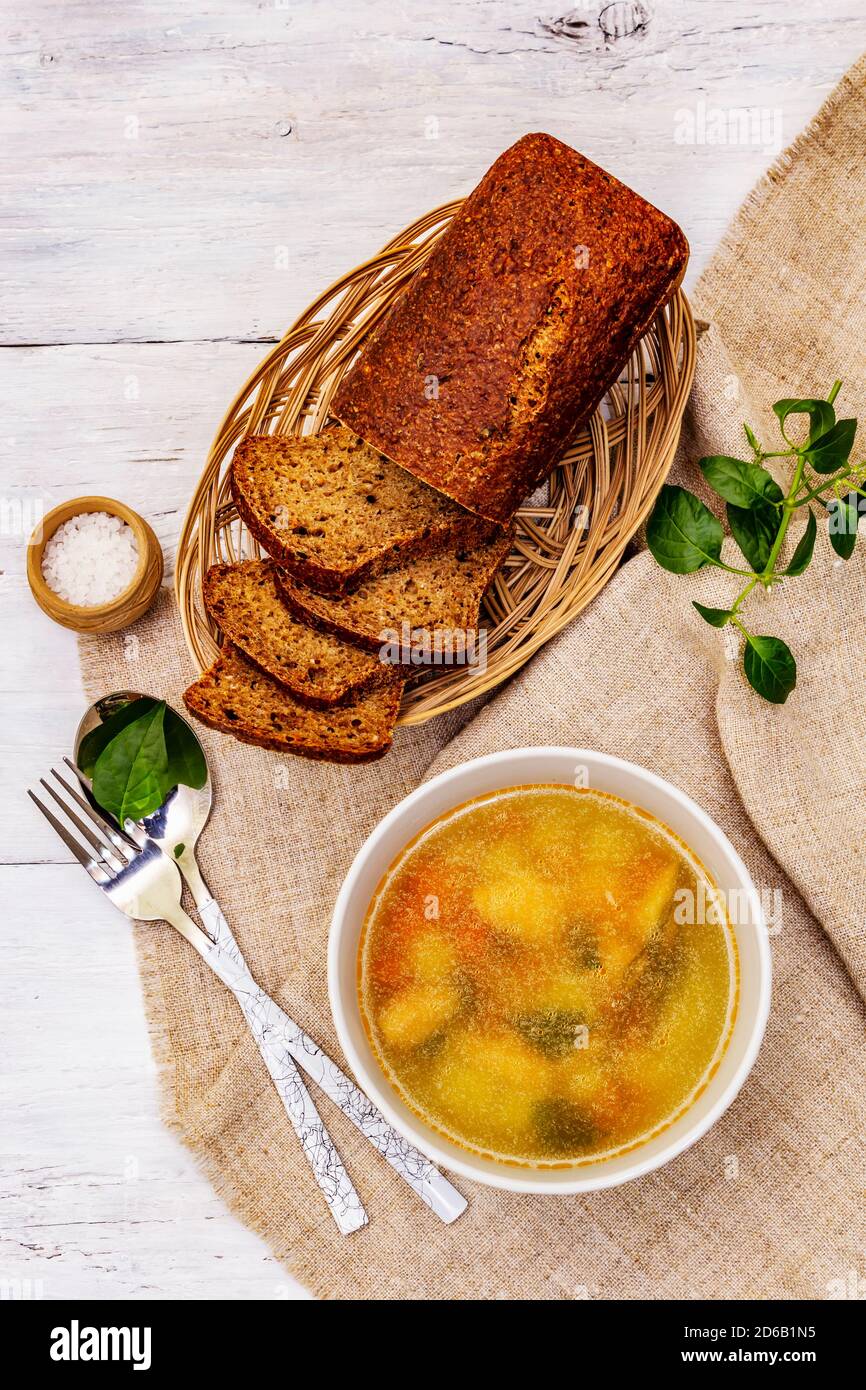 Trout soup with cutting vegetables and toasted bread. Traditional hot ...