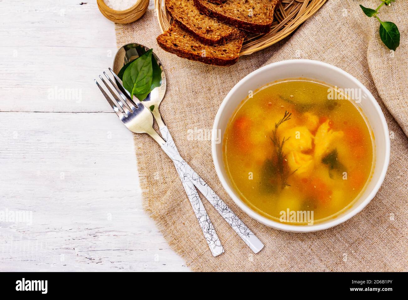 Trout soup with cutting vegetables and toasted bread. Traditional hot ...