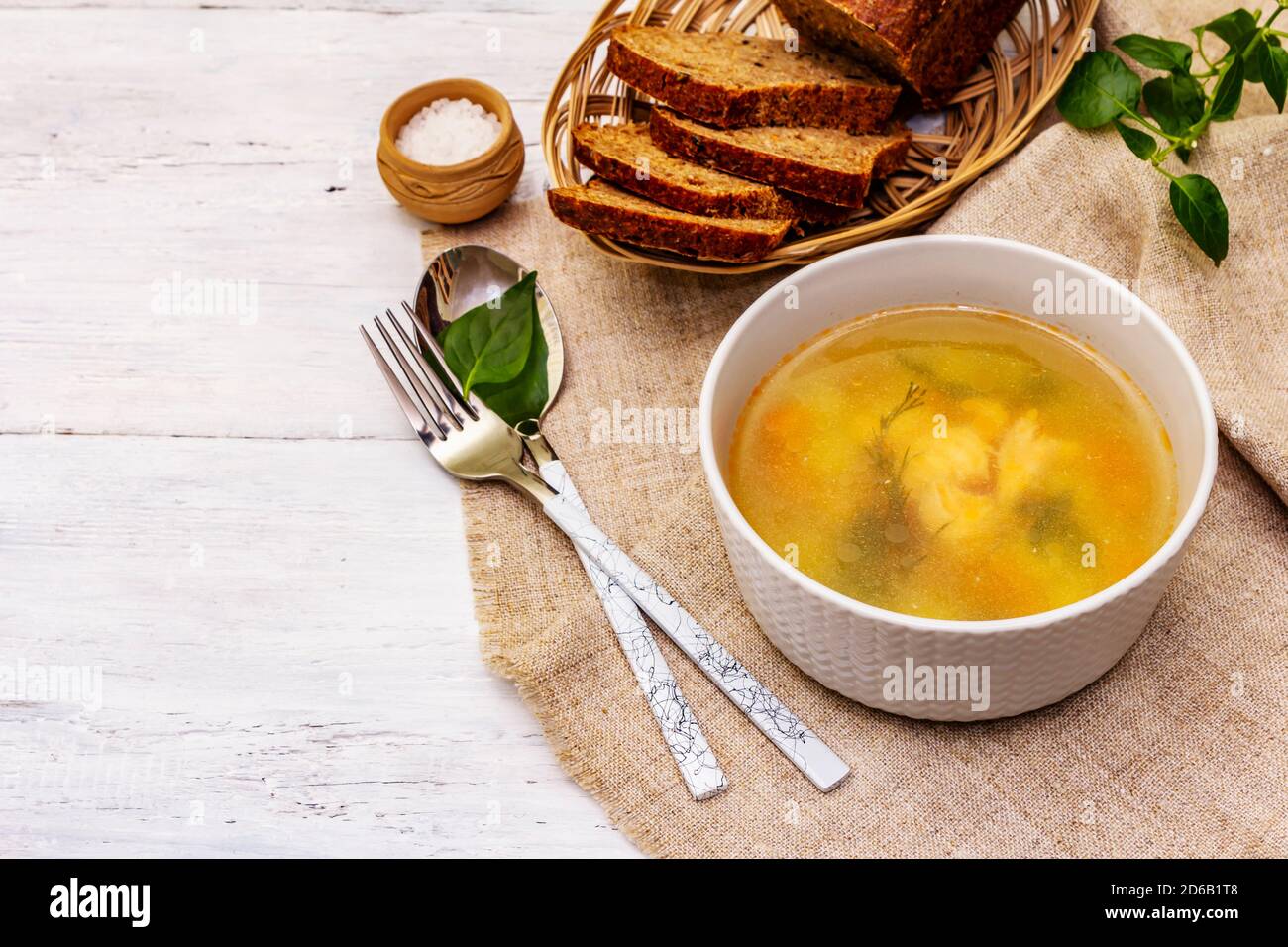 Trout soup with cutting vegetables and toasted bread. Traditional hot ...