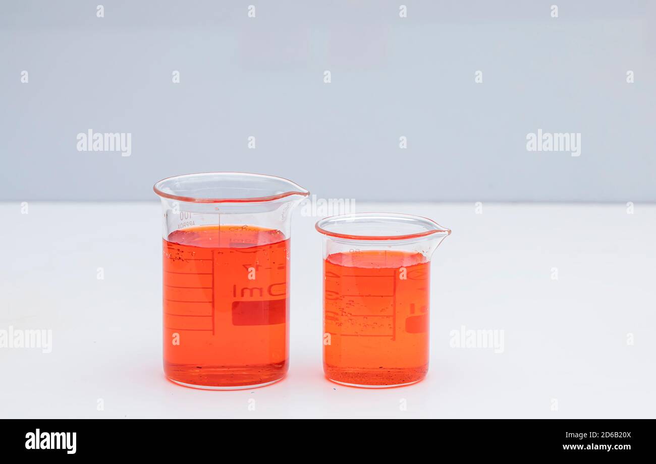 Beaker with color liquid. Solution chemistry. Laboratory beaker with ...
