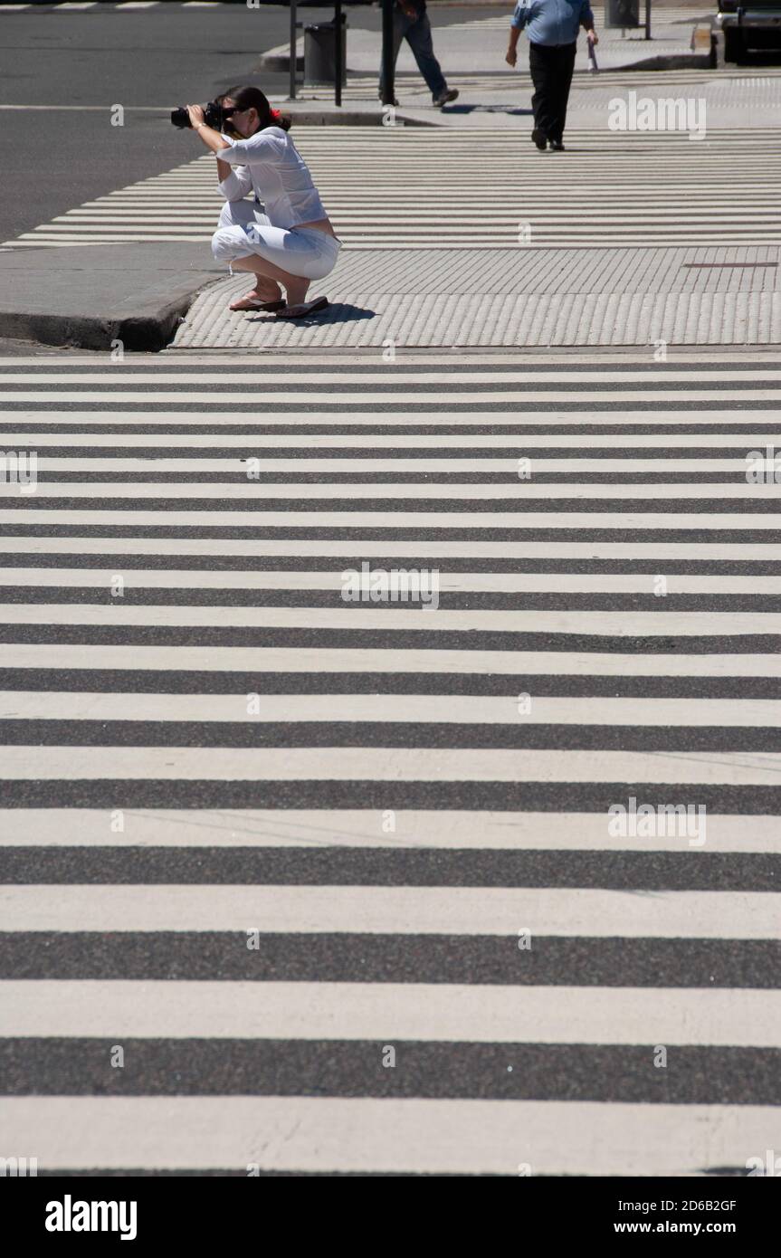 Long zebra crossing and photographer Stock Photo - Alamy
