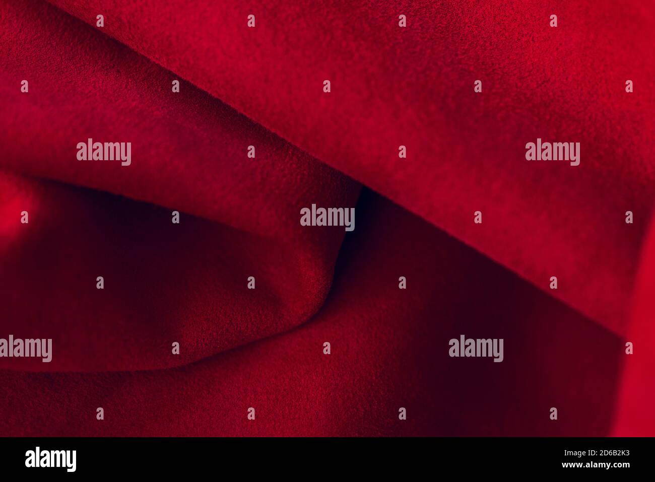 Red matte background of suede fabric, closeup. Velvet texture of ...