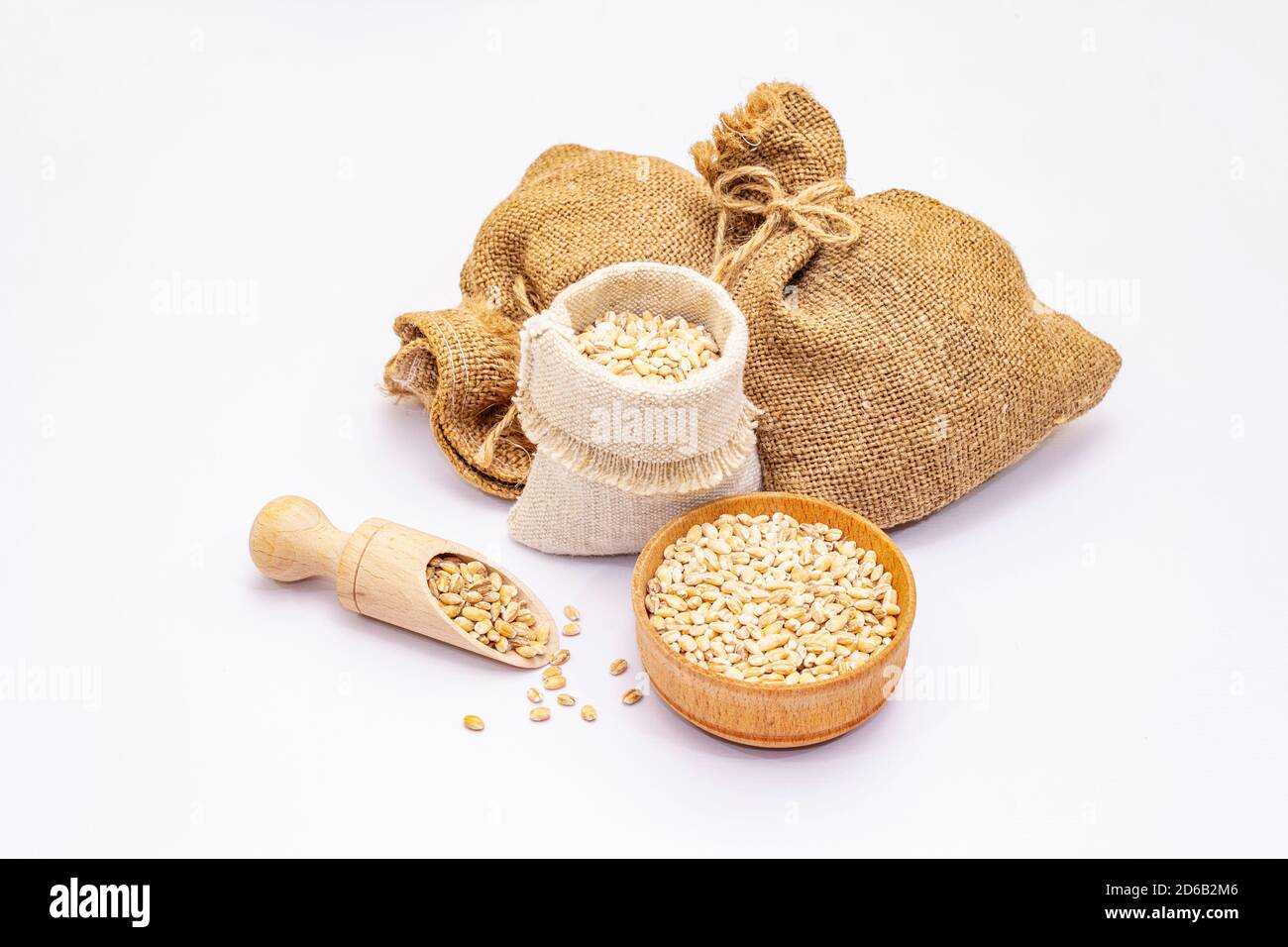 Whole peeled pearl barley grains isolated on white background. A ...