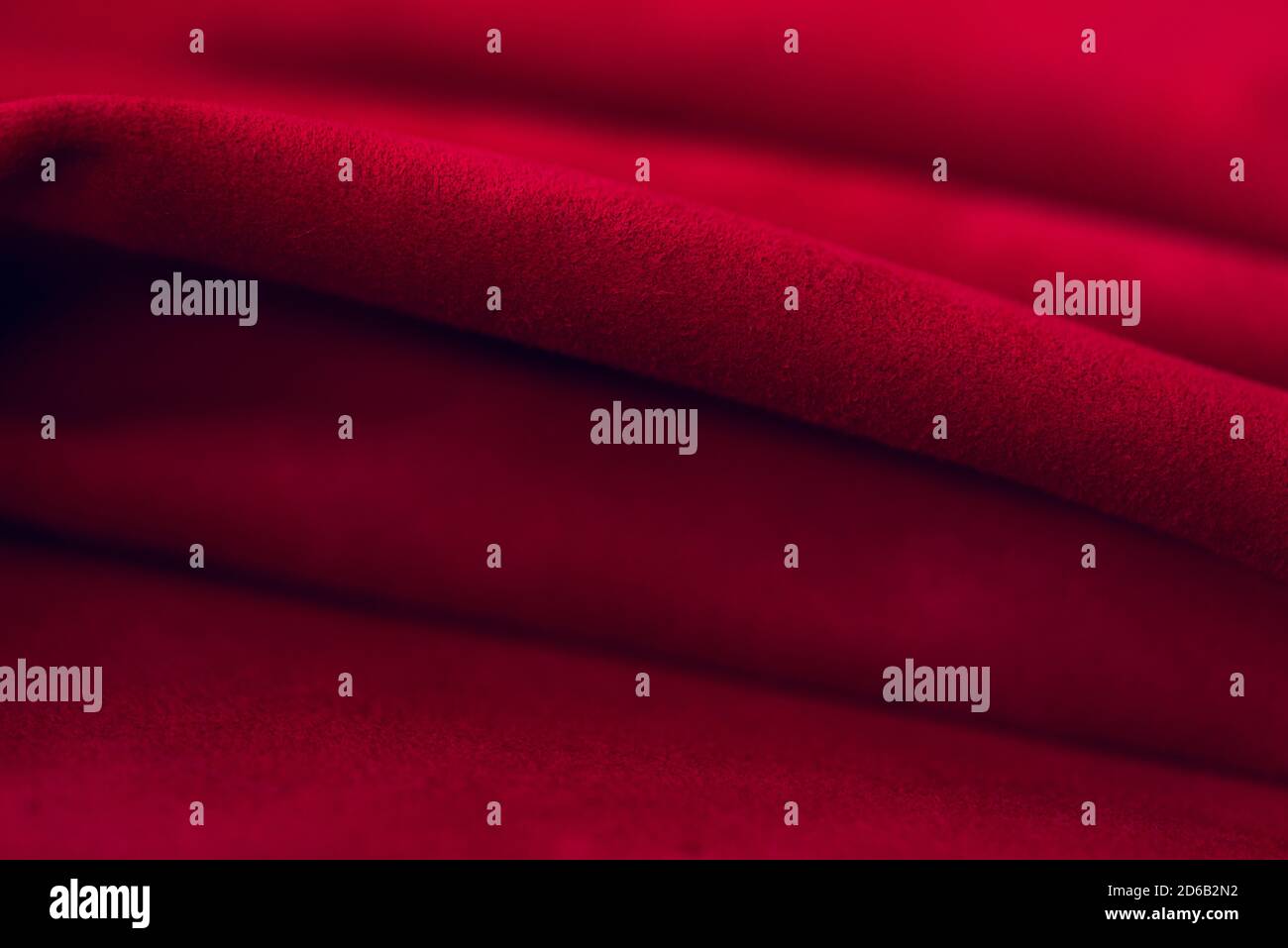 Red matte background of suede fabric, closeup. Velvet texture of ...