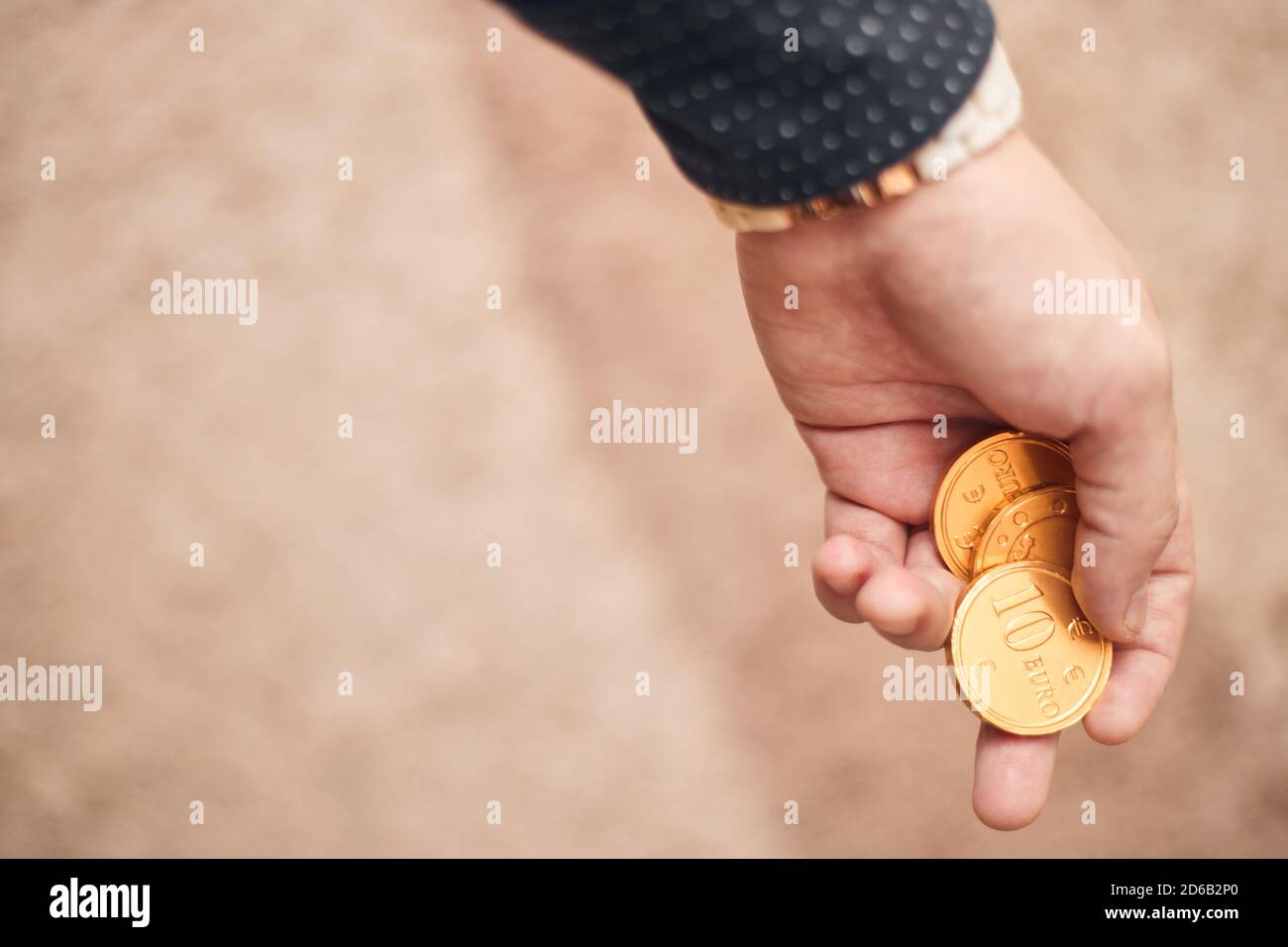 Gold coins in hand on light background Stock Photo - Alamy