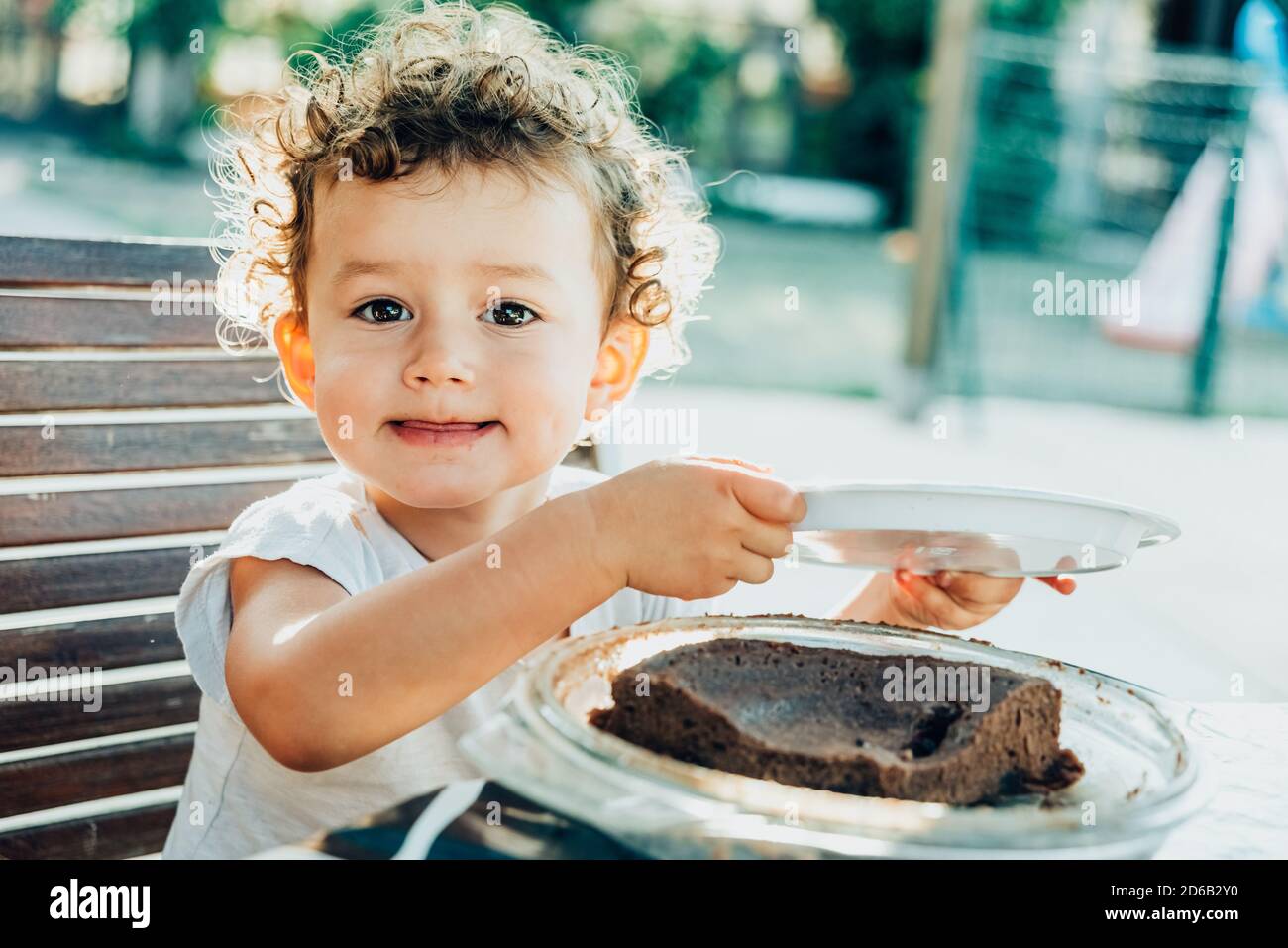 young lady enjoys a chocolate cake for a snack Stock Photo - Alamy