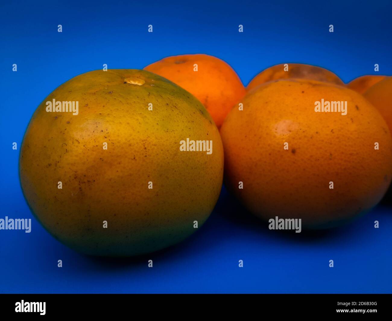 orange tangerines on a blue background Stock Photo - Alamy