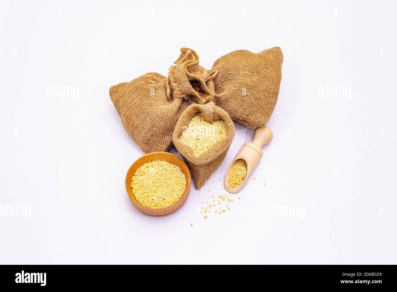 Whole peeled millet grains isolated on white background. A traditional ...