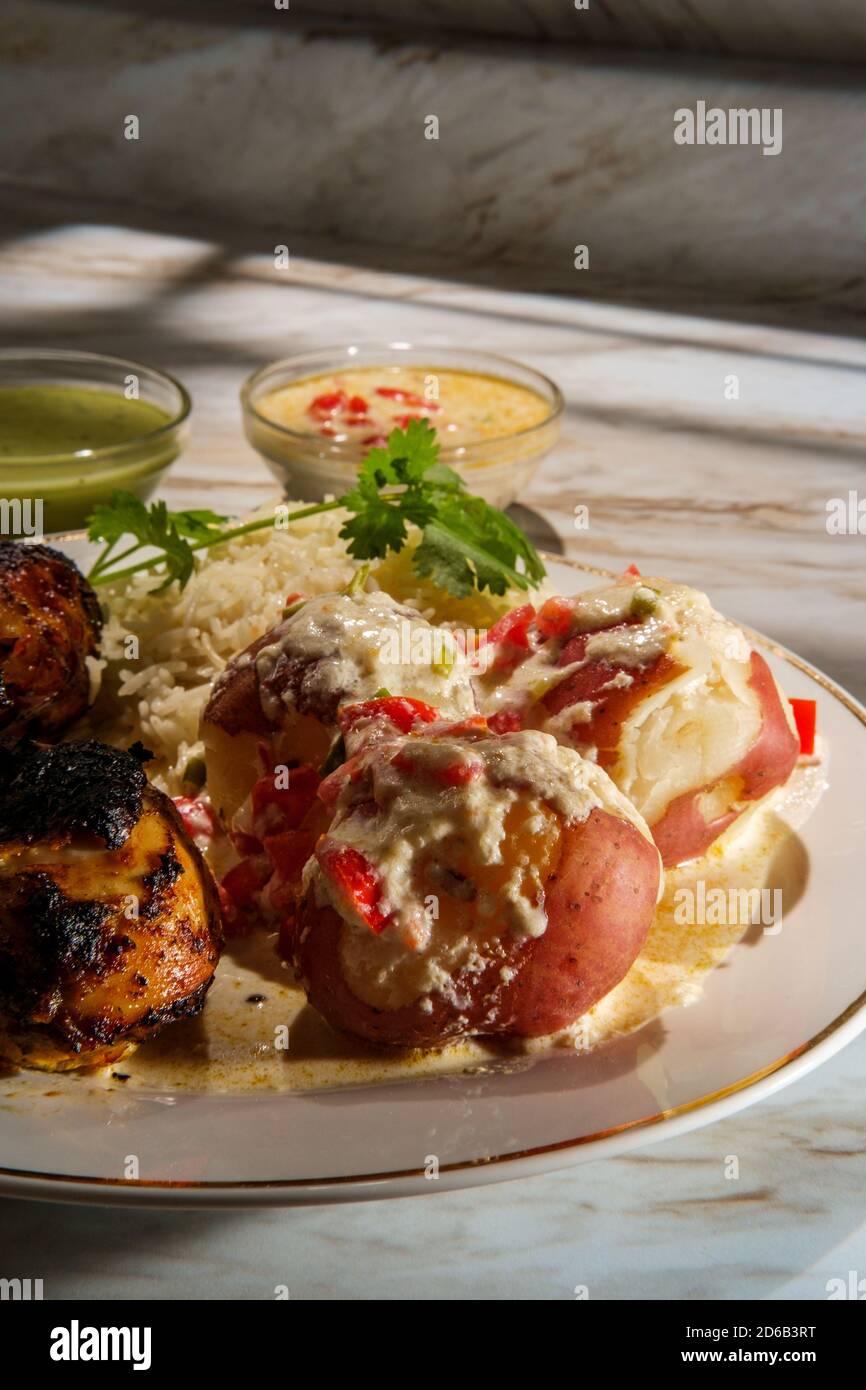 Colombian cuisine papas chorreadas roasted chicken legs and rice Stock ...