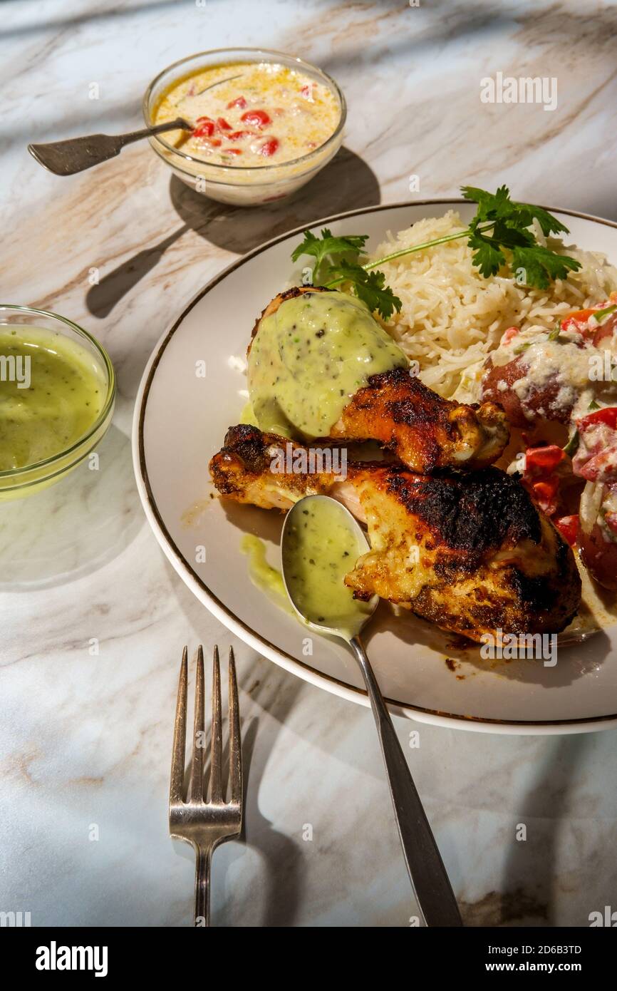 Colombian cuisine papas chorreadas roasted chicken legs and rice Stock ...