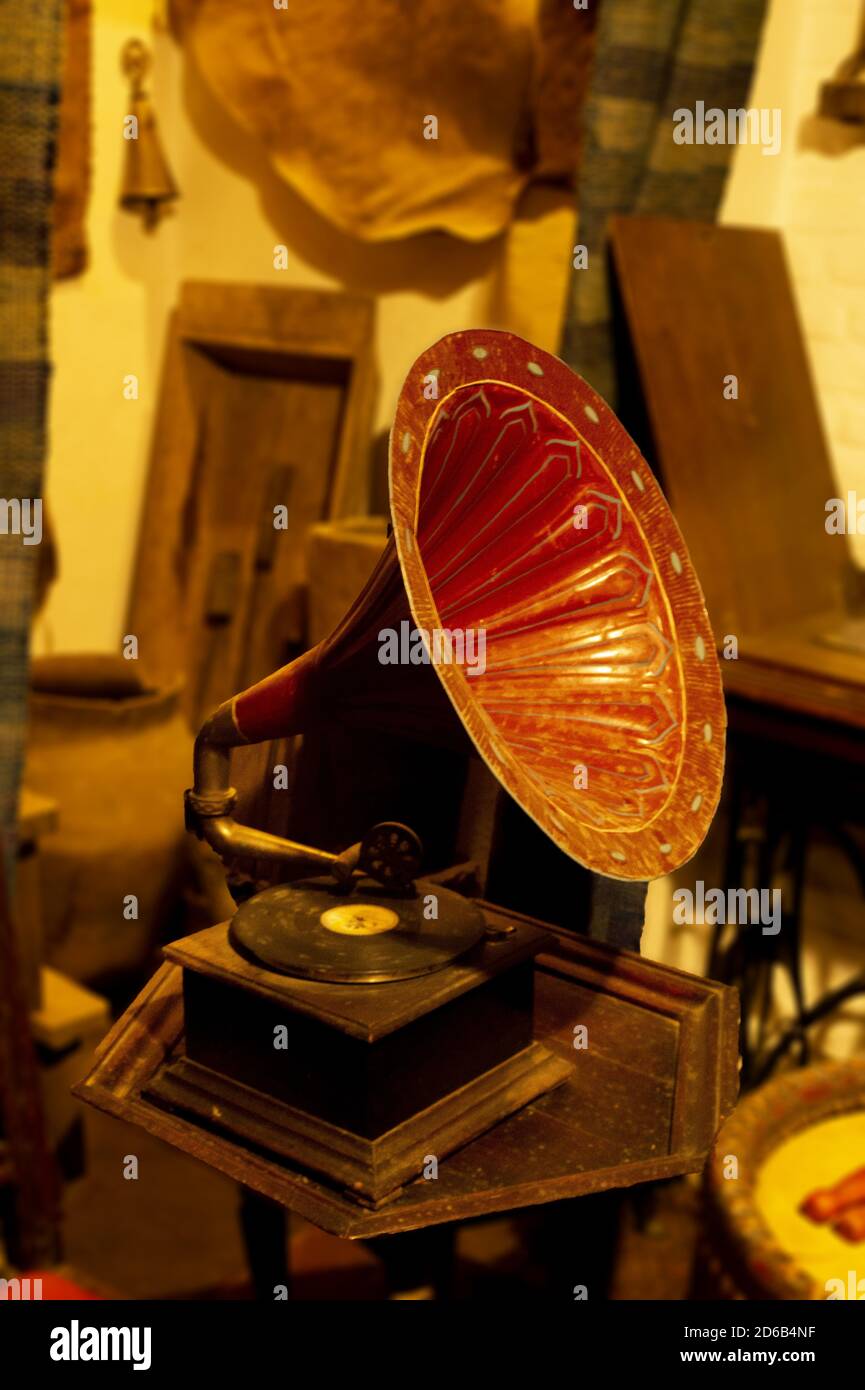 Vertical shot of a small gramophone surrounded by vintage items under ...