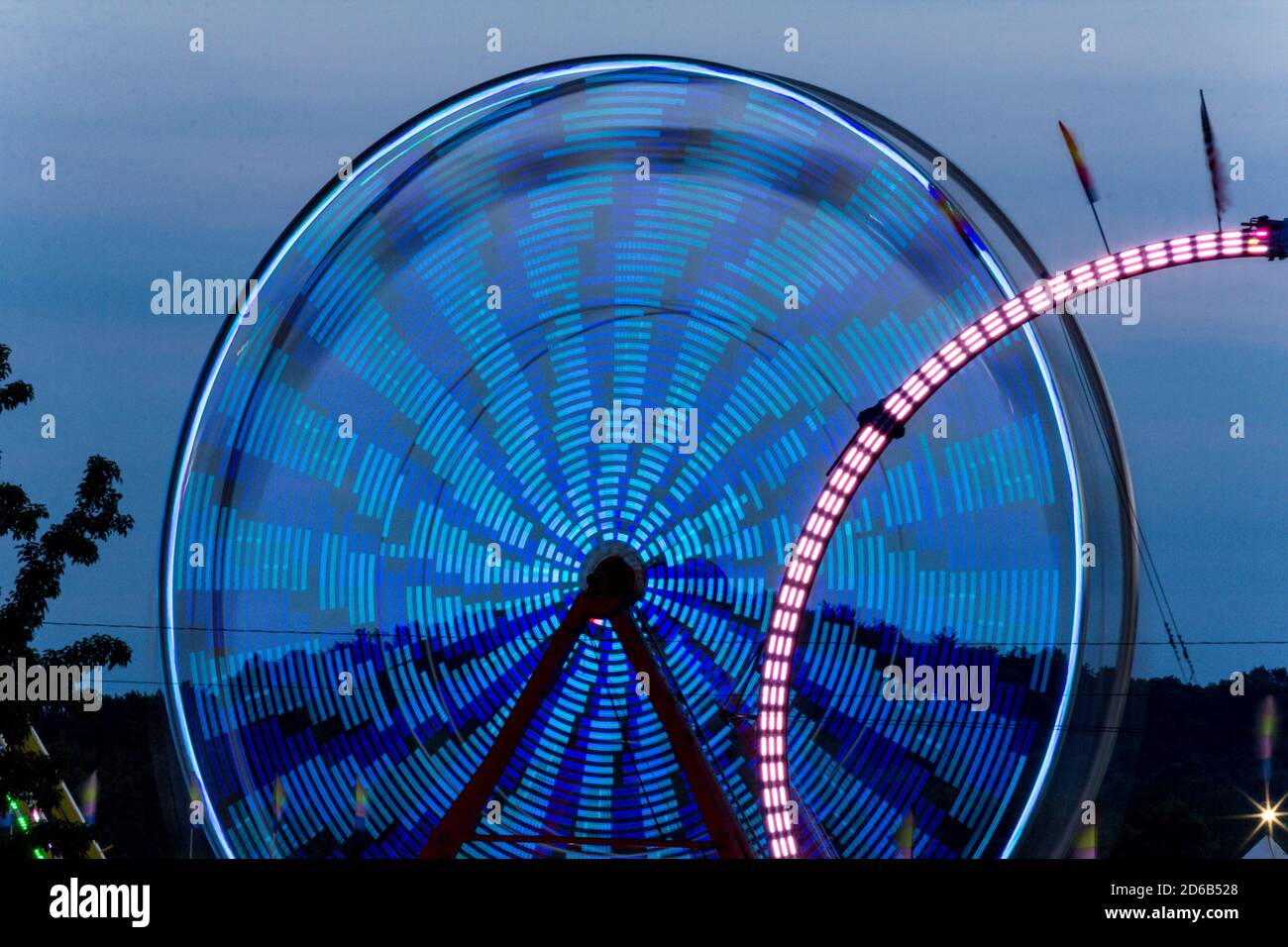Summer carnival ferris wheel at night with light blur time lapse Stock ...