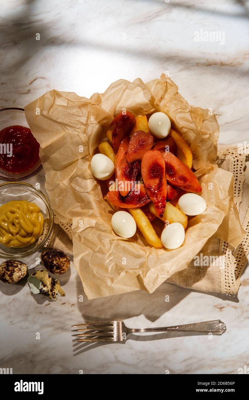 Peruvian fast-food salchipapas french fries and sliced sausage with ...