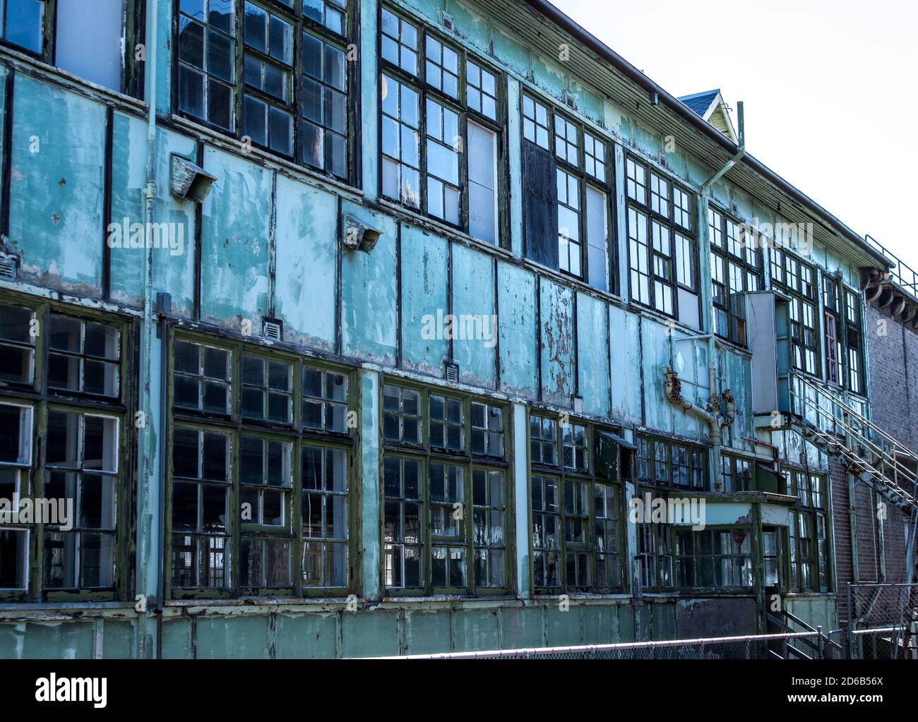 Industrial weathered urban building with rusting window grill and ...