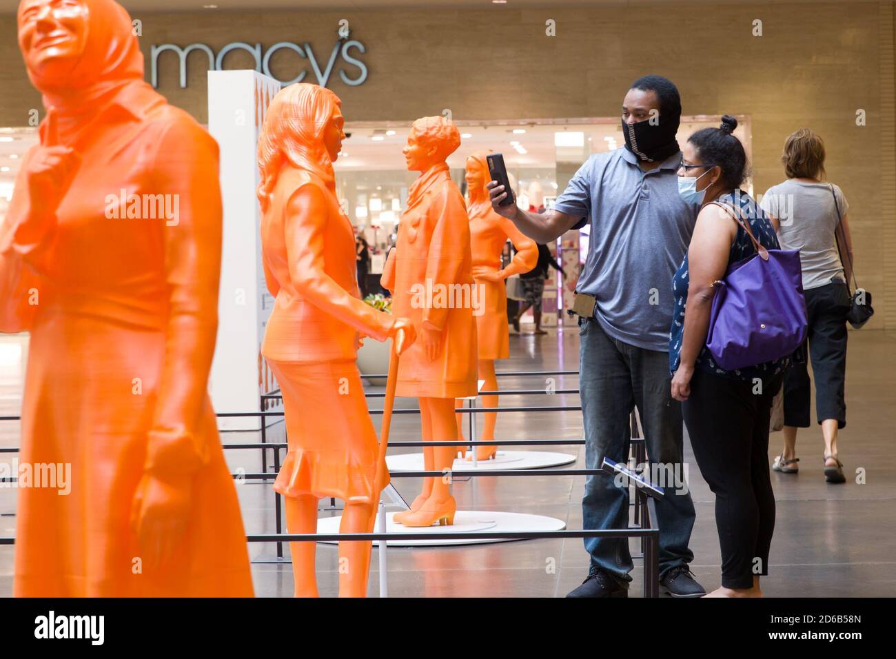 Dallas, USA. 15th Oct, 2020. A man takes photo of a statue on display ...