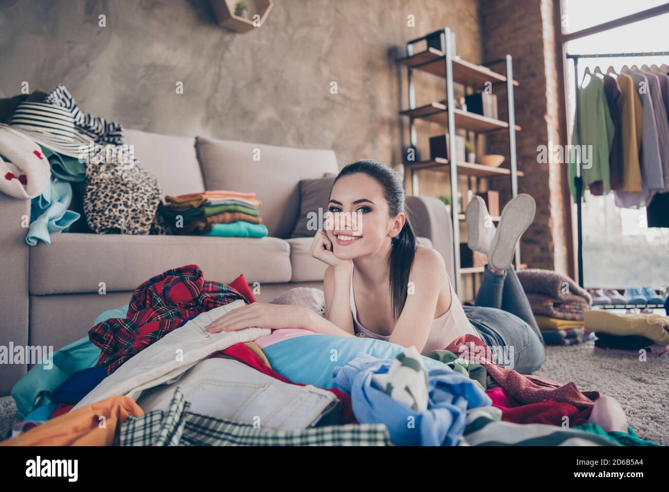 Photo of pretty lady stay home quarantine lying many clothes heap stack ...