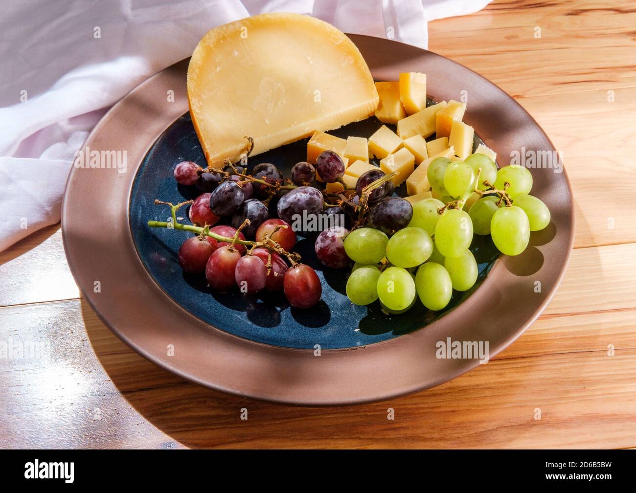 Gouda cheese fancy gourmet snack plate with tri-color grapes Stock ...