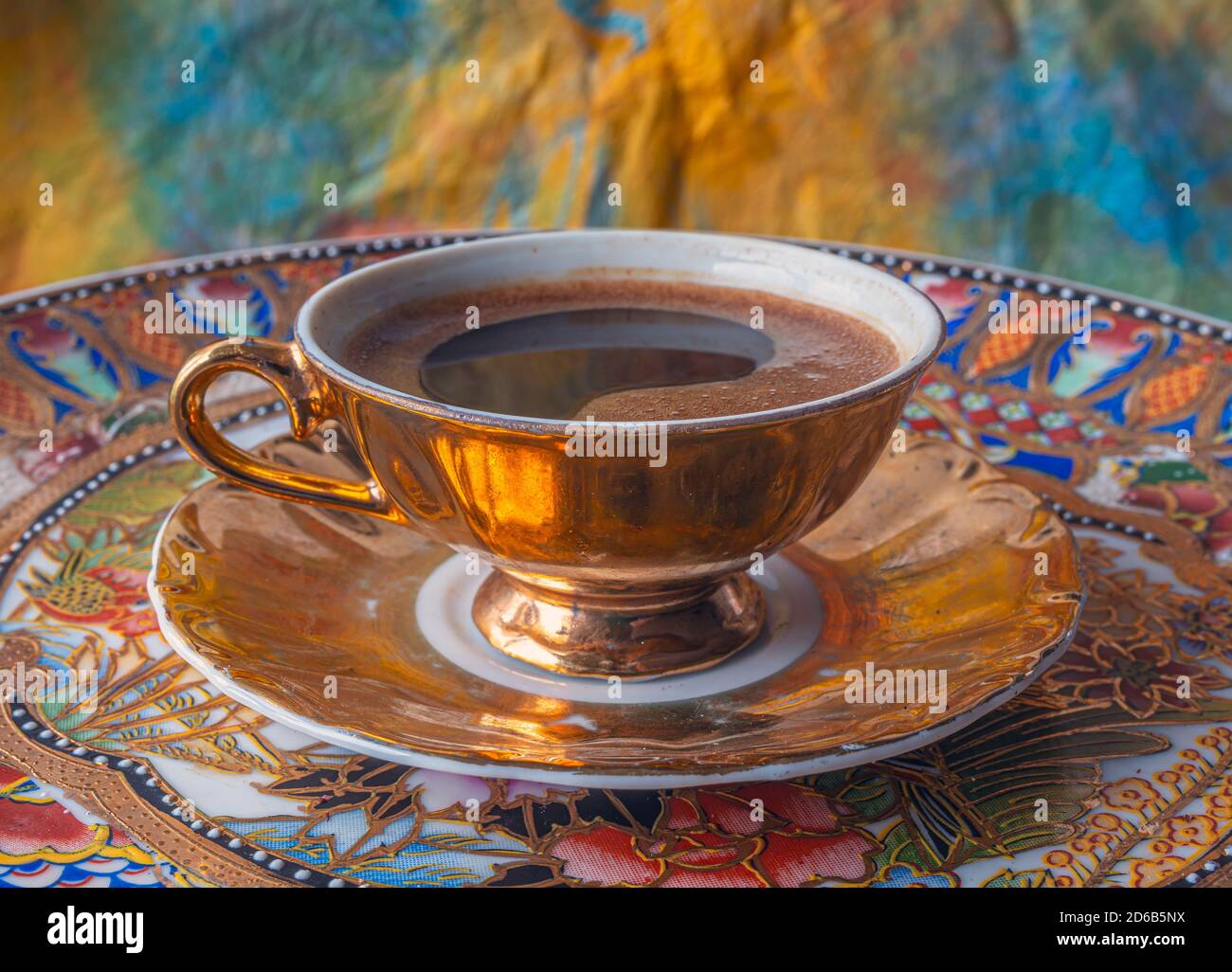 Gold Cup of coffee in still life Stock Photo - Alamy