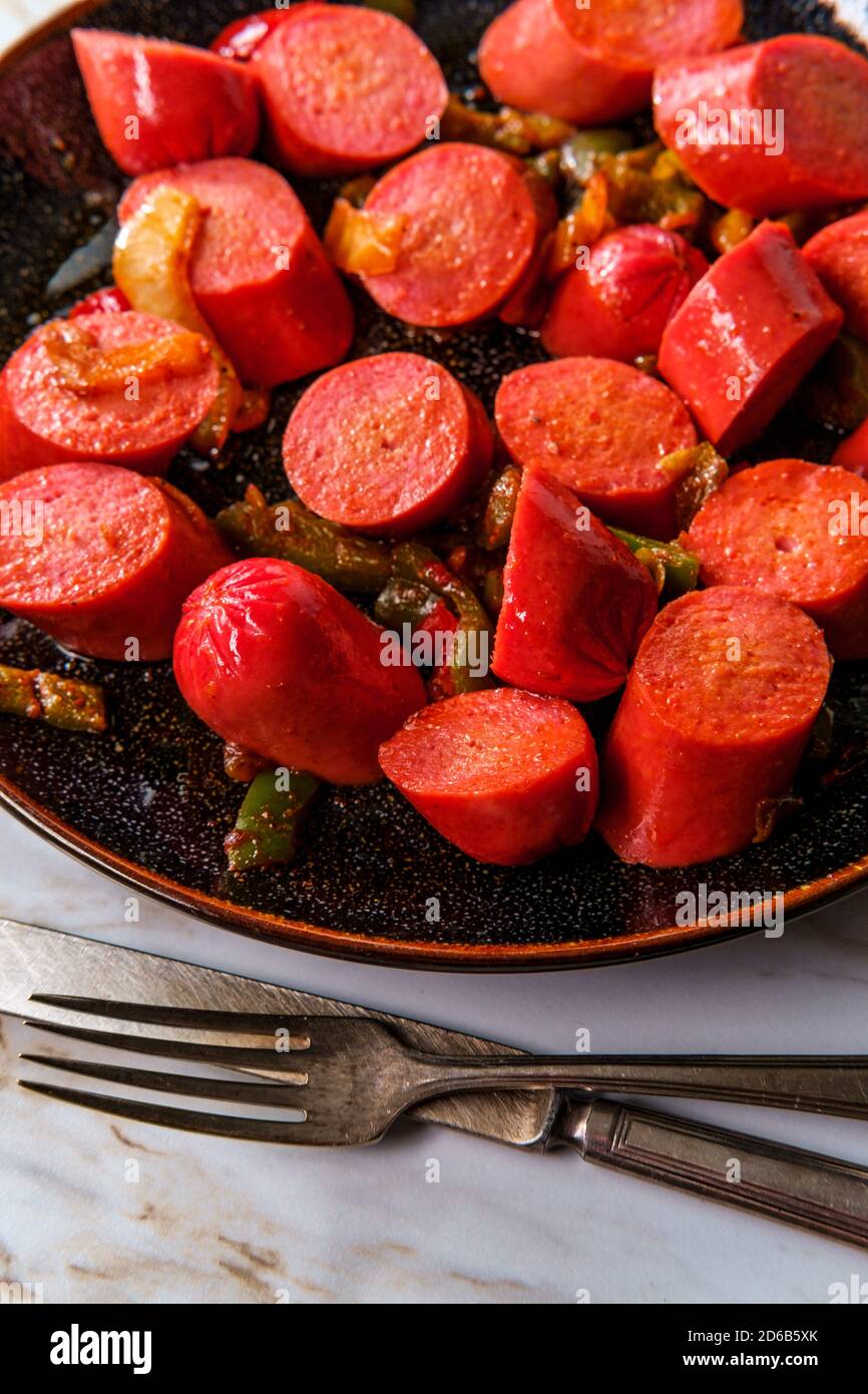 Hot spicy sausage with sliced peppers and onions Stock Photo - Alamy