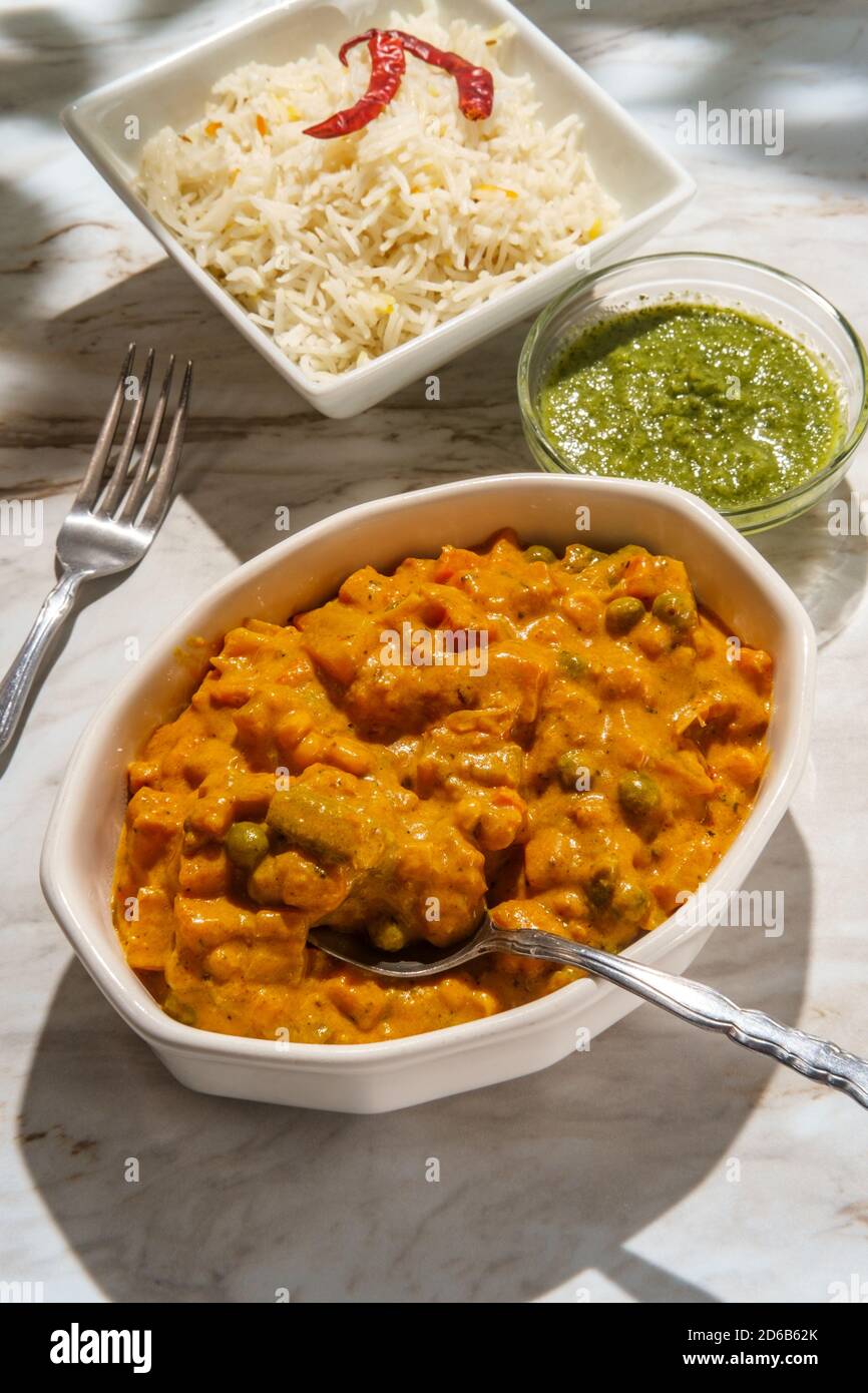 Authentic Indian vegetable korma curry dinner with green chutney and ...