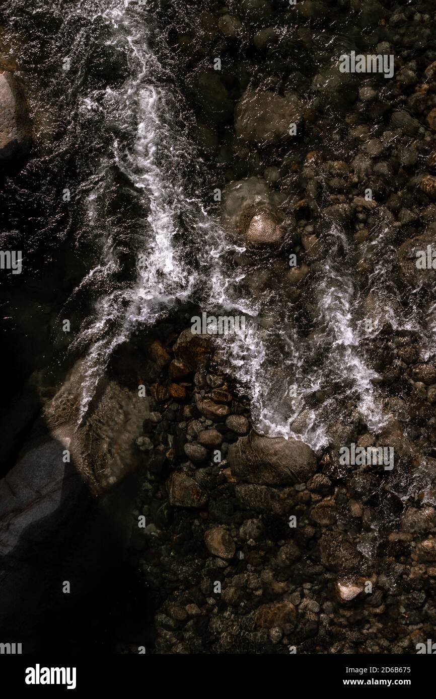Top view of a river surrounded by rocks under the sunlight - perfect ...