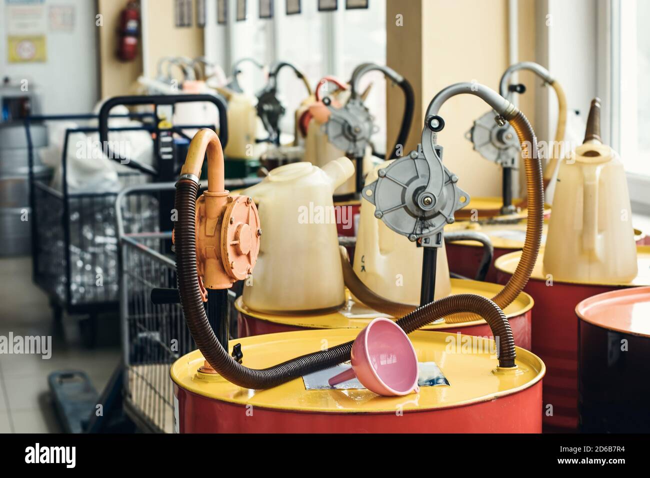 Motor oil in barrels with pump indoors with copy space. Store of lube ...