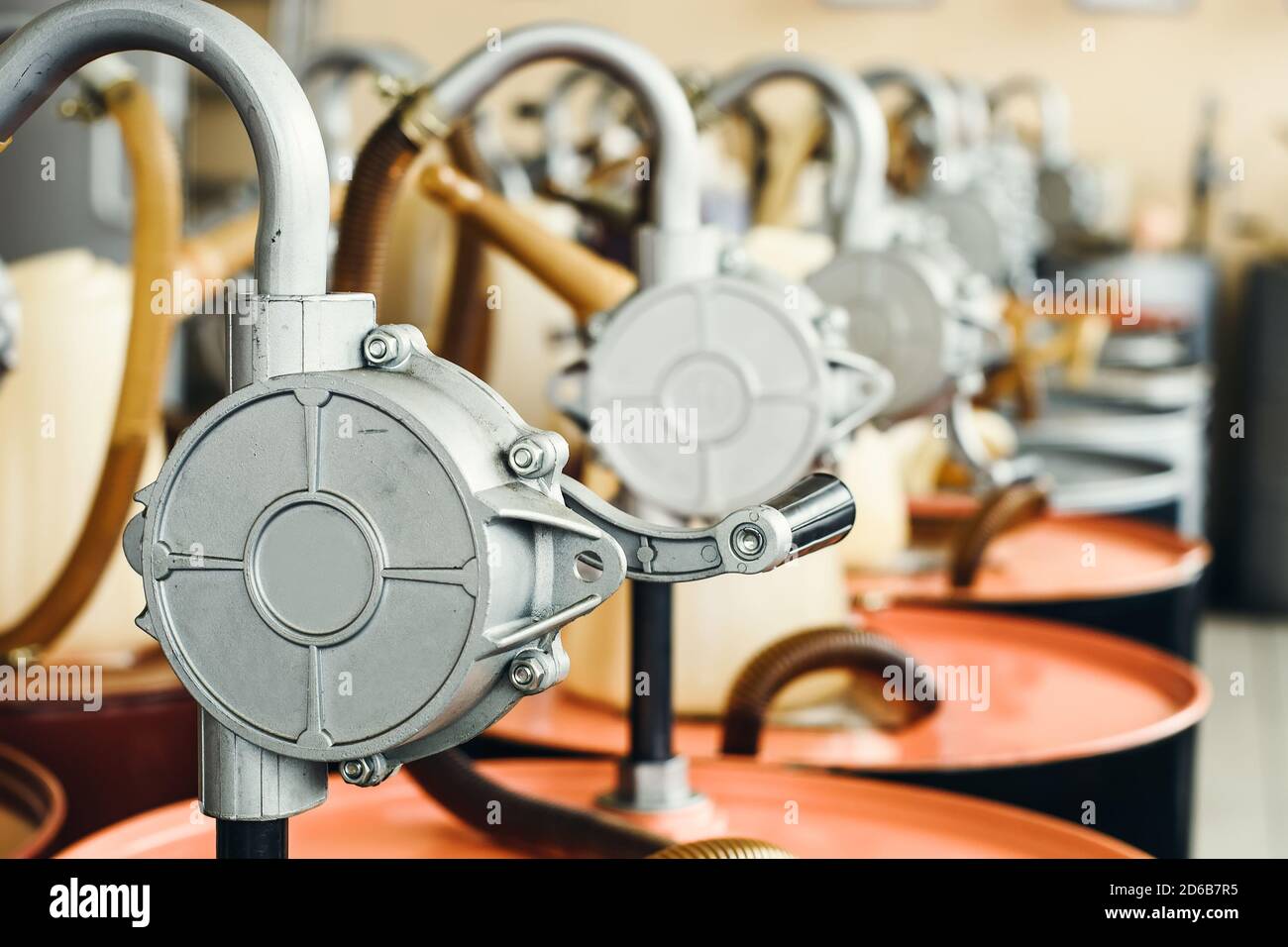 Motor oil in barrels with pump indoors with copy space. Store of lube ...