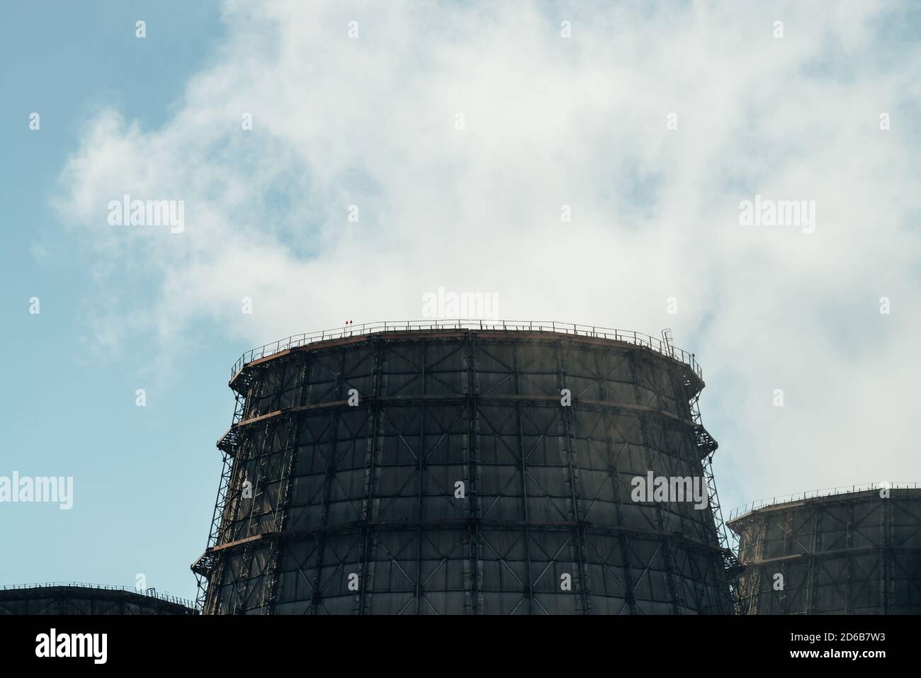 Three big tower of CHPP close-up. White steam from wide pipe of CHP on ...