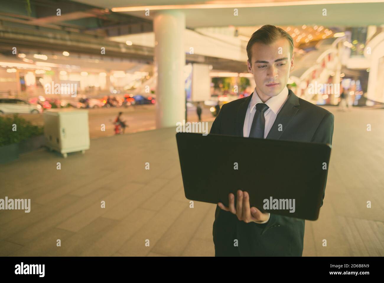 Young businessman exploring the city of Bangkok, Thailand at night ...