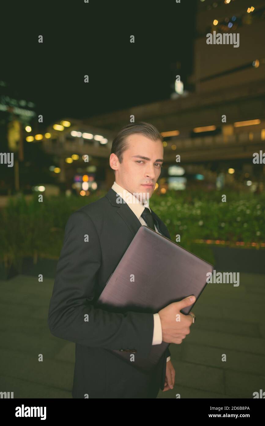 Young businessman exploring the city of Bangkok, Thailand at night ...