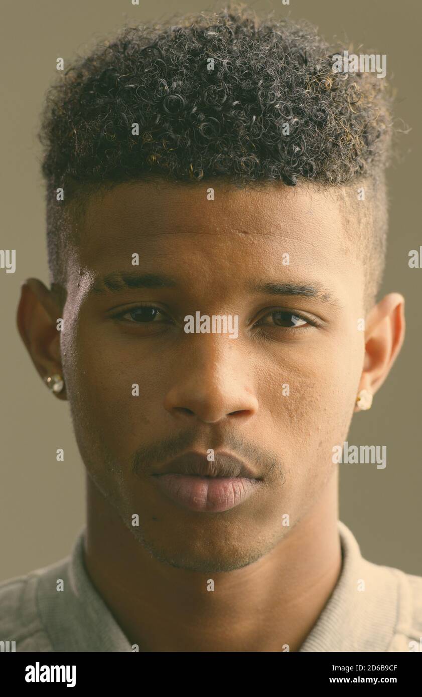 Face of young handsome African man with afro hair Stock Photo - Alamy