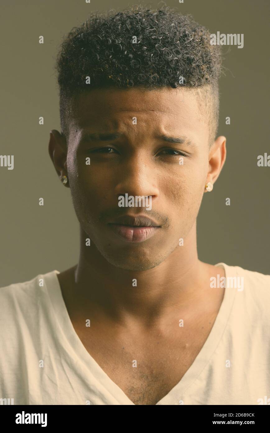 Face of young handsome African man with afro hair Stock Photo - Alamy