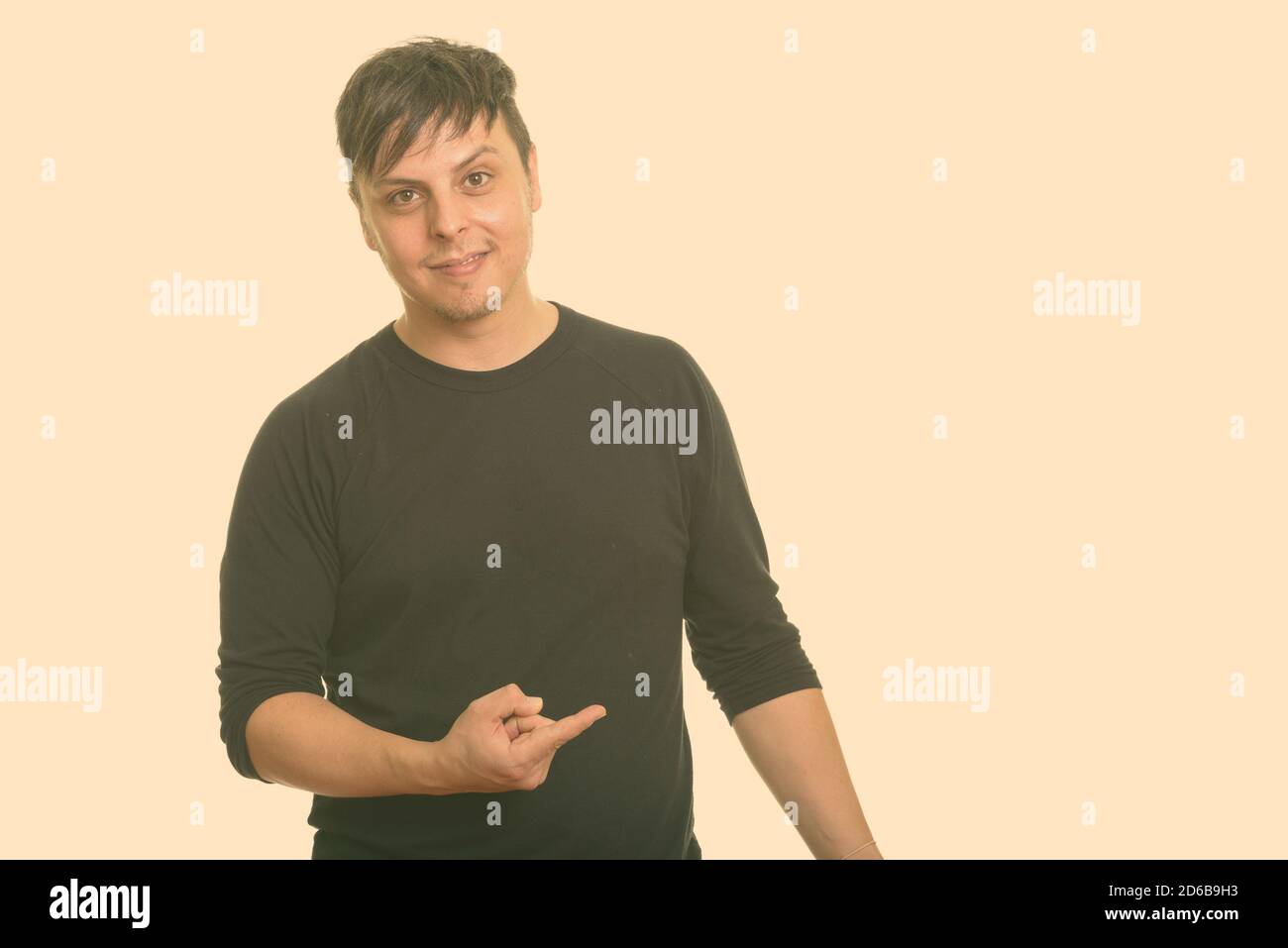 Studio shot of man pointing finger to the side Stock Photo - Alamy