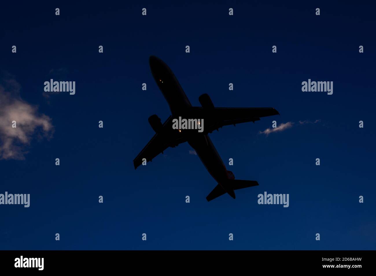 Silhouette airplane flying Stock Photo - Alamy