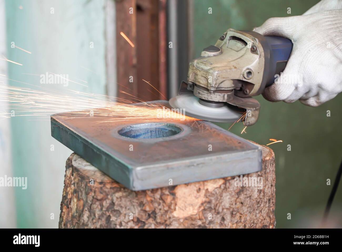 Worker with Angle Grinder does Metalworking in Industrial Environment ...