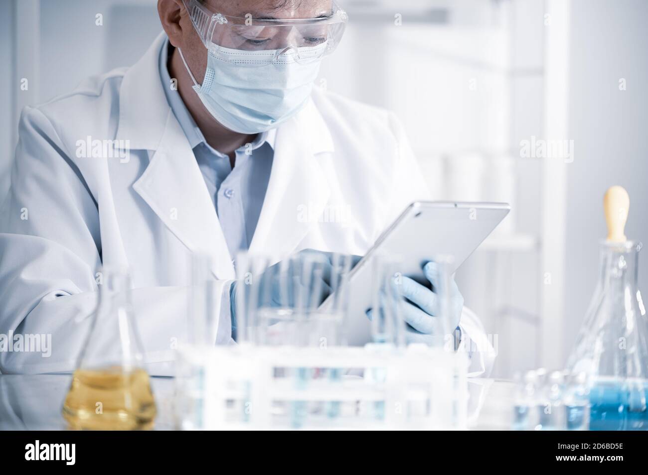 Asian male scientist working in a laboratory. Vaccine development ...