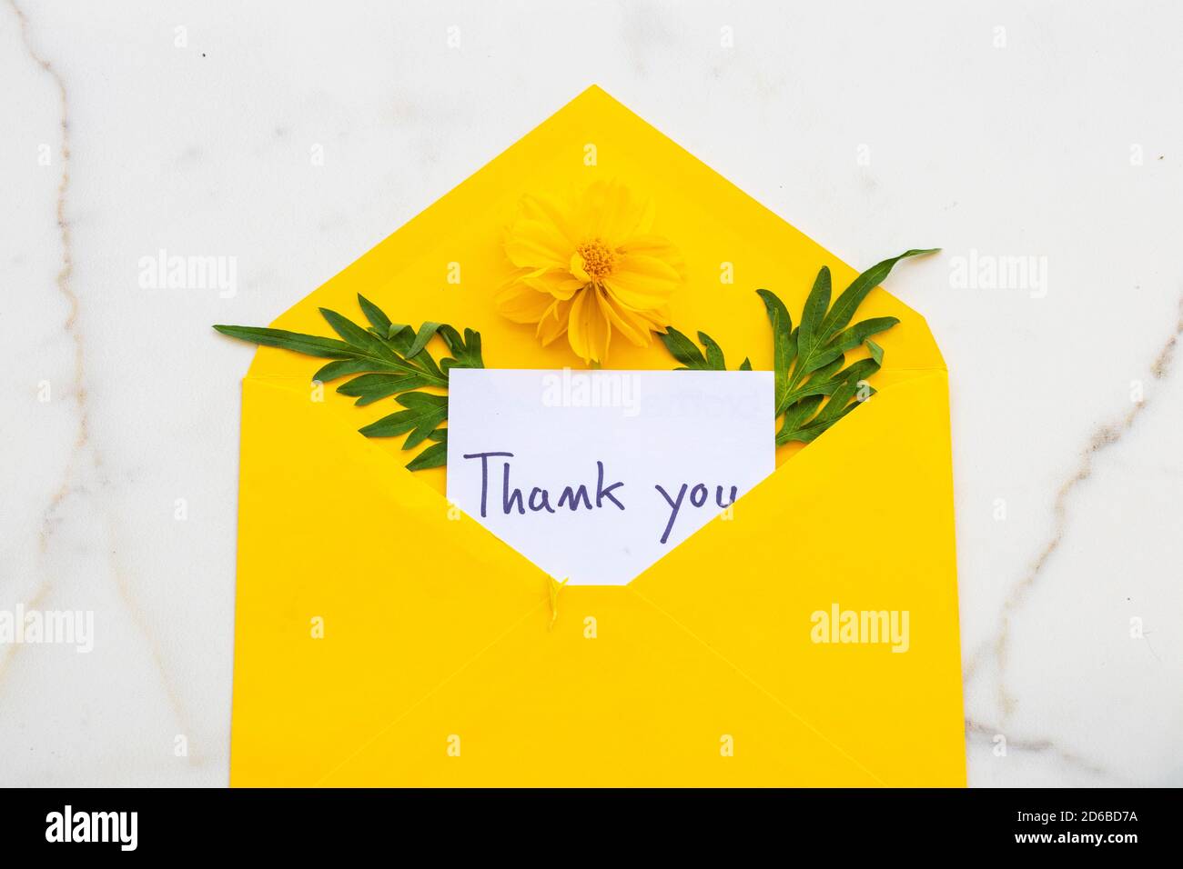 thank you message card handwriting in envelope and yellow flowers ...