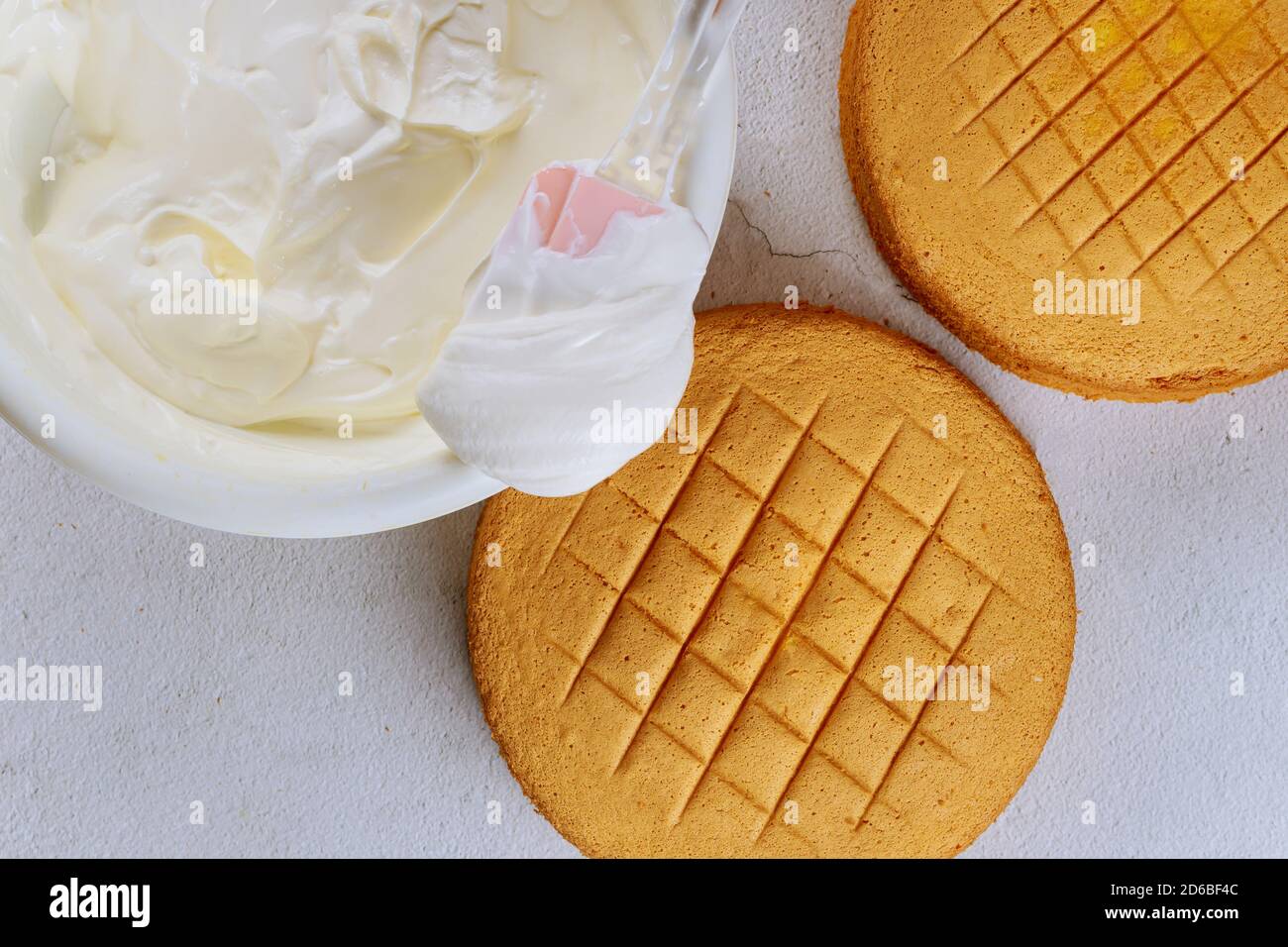 Technique of cake assembly.Frosting and sponge cake. Top view Stock ...