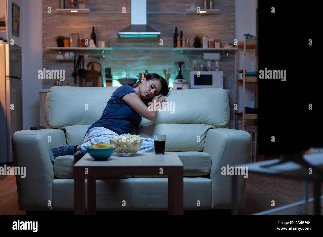 Young tired after work woman looking asleep in the evening in front of ...