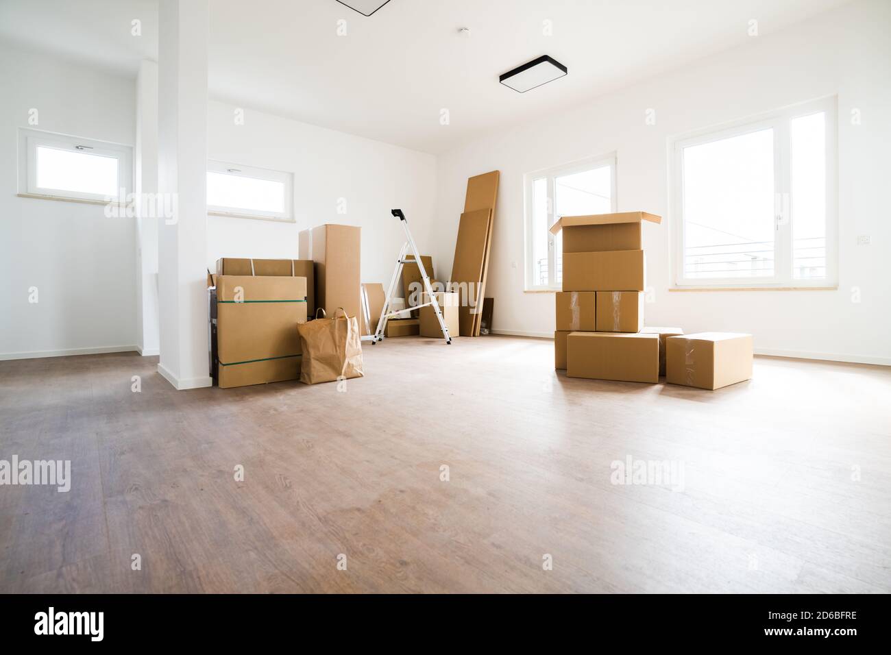 Empty Room With Moving Boxes Or Cartons Stock Photo - Alamy