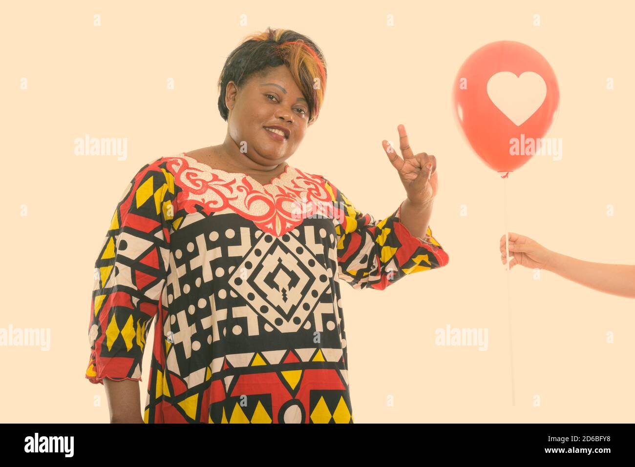 Studio shot of happy fat black African woman smiling while giving peace ...