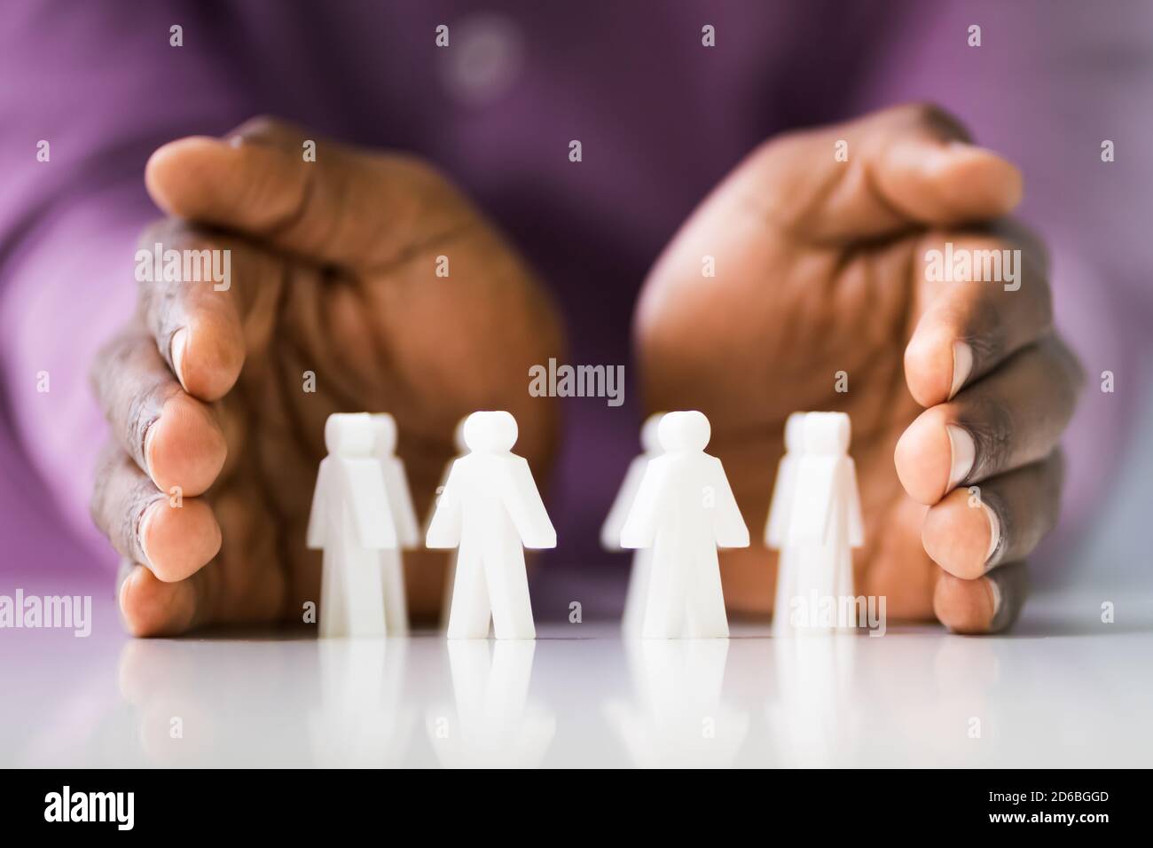 African American Hands Protecting Figures. Safety And Protection Stock ...