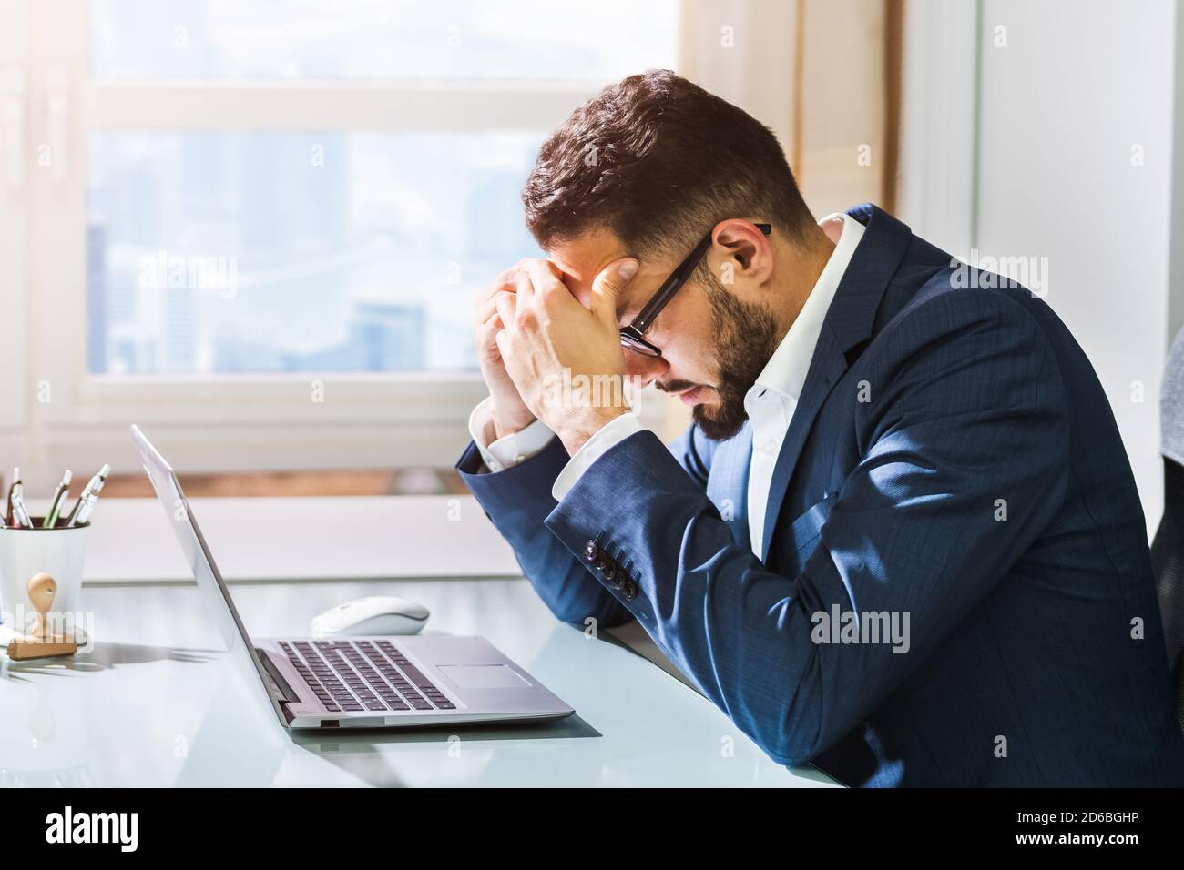 Unhappy Sad Man With Migraine Using Laptop Computer Stock Photo - Alamy