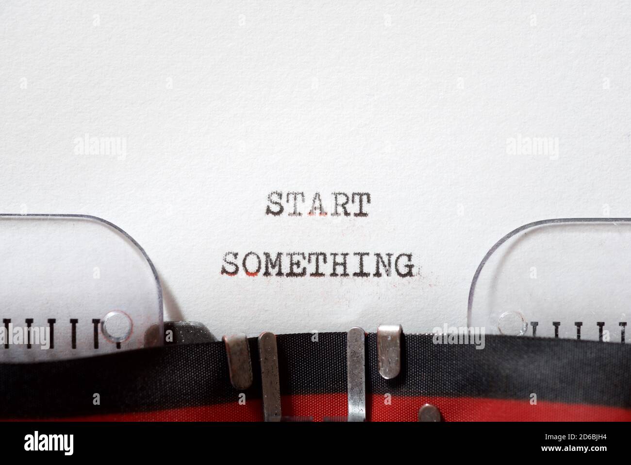 Start something phrase written with a typewriter Stock Photo - Alamy